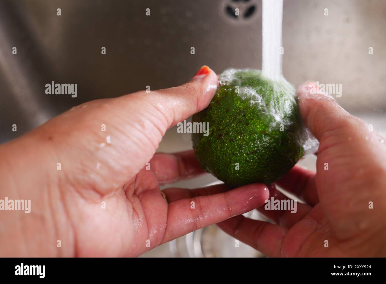 hand washing avocado with water sprinkling Stock Photo - Alamy