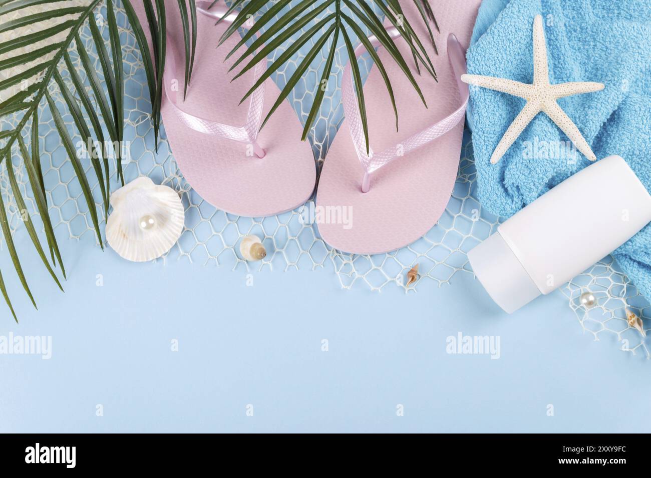 Summer holidays, pink beach slippers flip flops, towel, palm tree ...