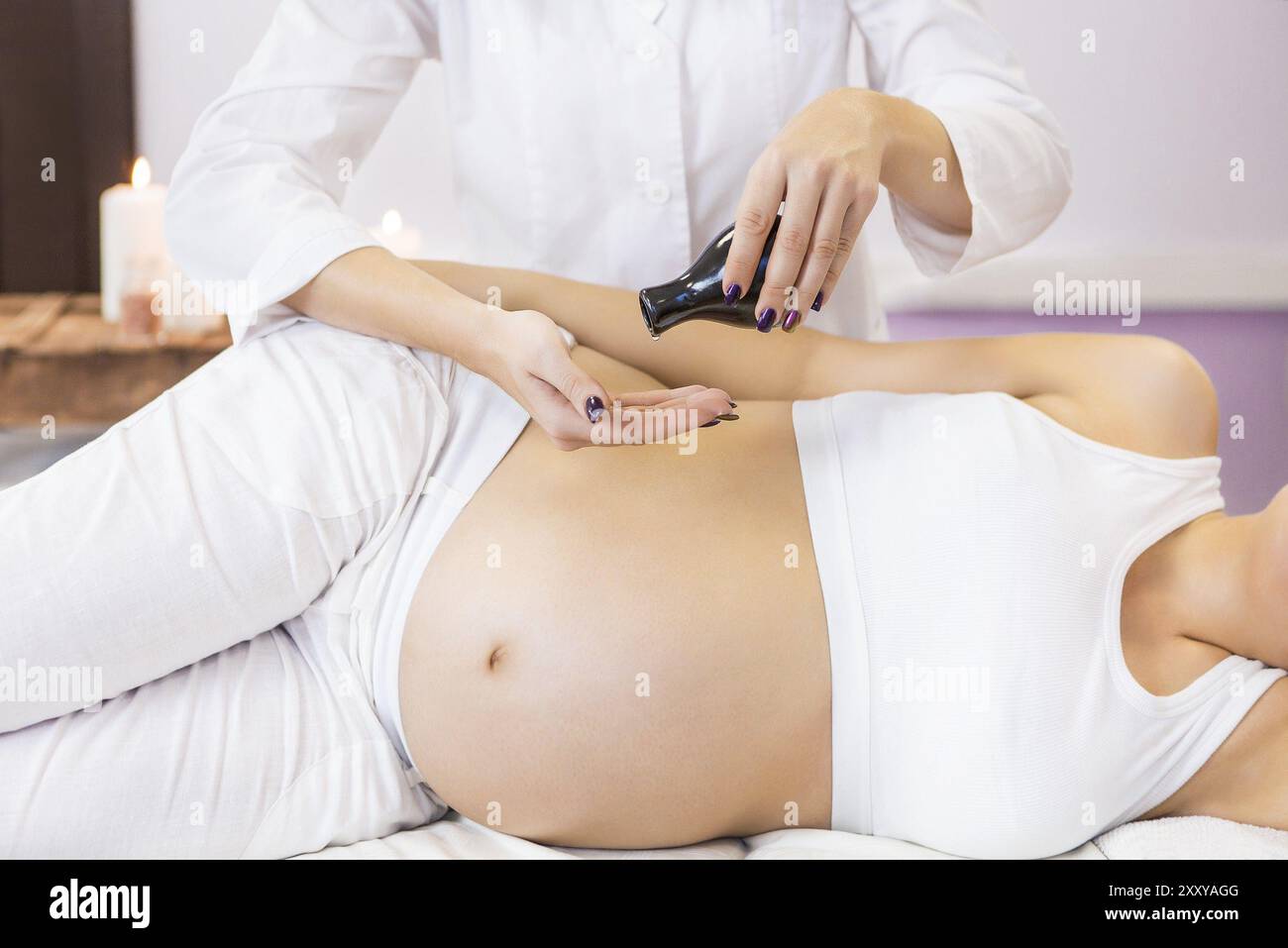 Young pregnant woman have massage treatment at spa salon Stock Photo - Alamy