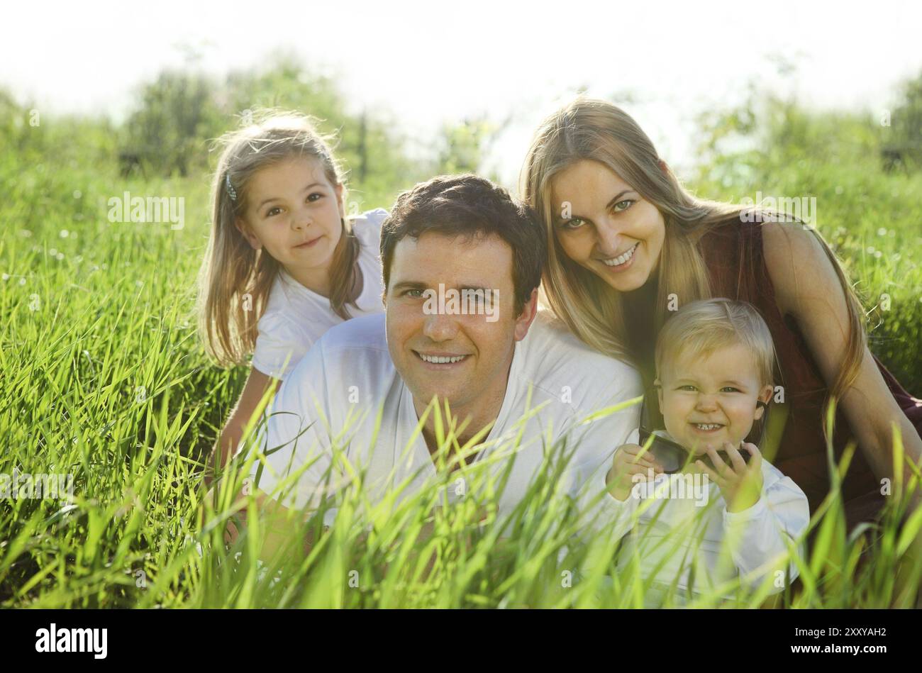 Happy young family with children outdoors Stock Photo - Alamy