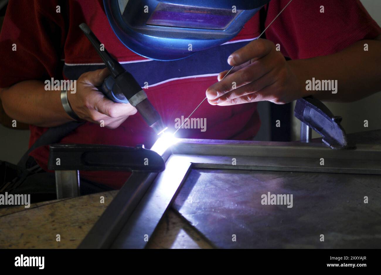 Welder welding a metal piece in th factory Stock Photo - Alamy