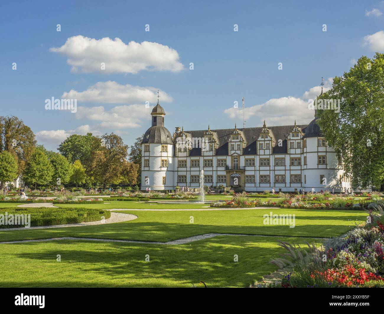 Historic castle surrounded by a spacious and well-tended garden under a ...