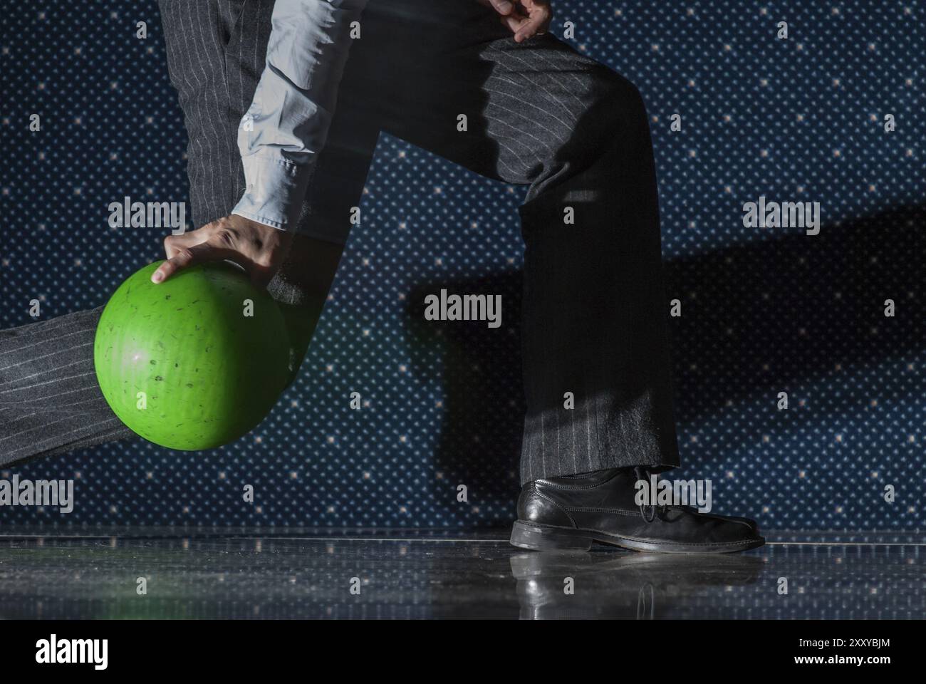Person throwing a green bowling ball Stock Photo - Alamy