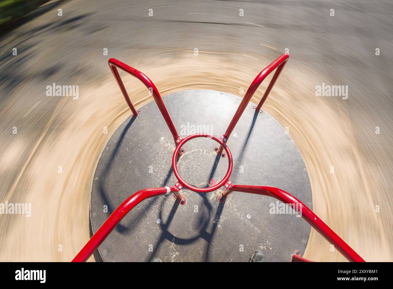 Standing on a red carousel in a playground Stock Photo - Alamy