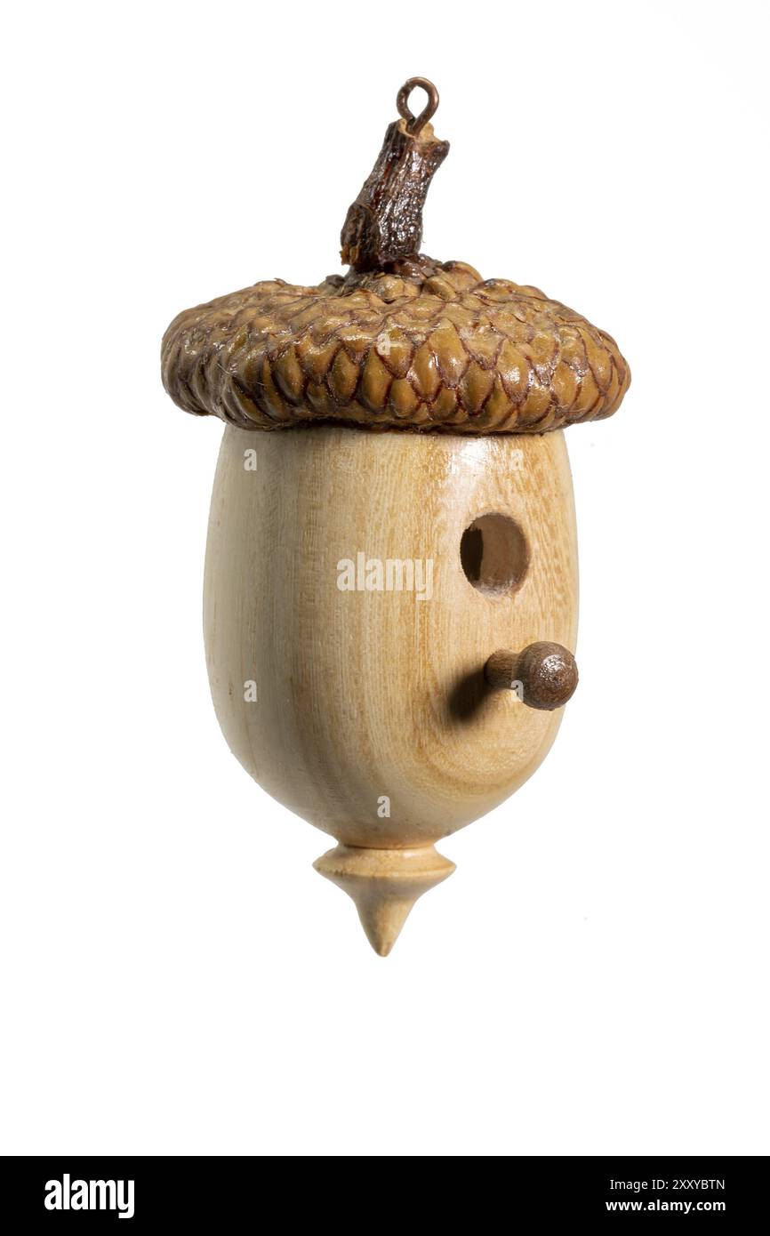 Small model of a bird nesting box turned with an acorn cap as a roof ...