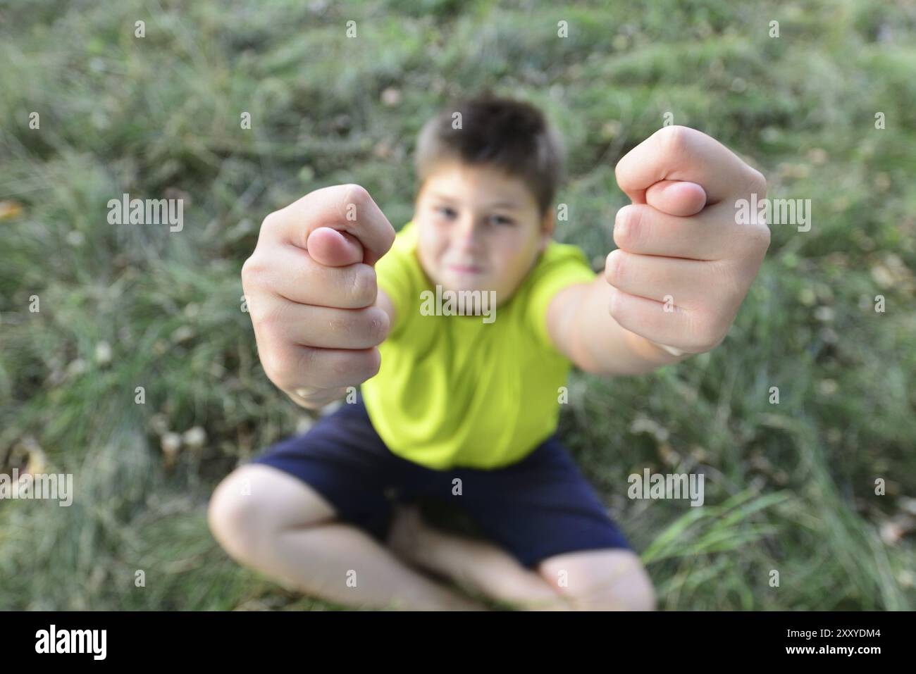 Teen boy shows the hand gesture Stock Photo - Alamy