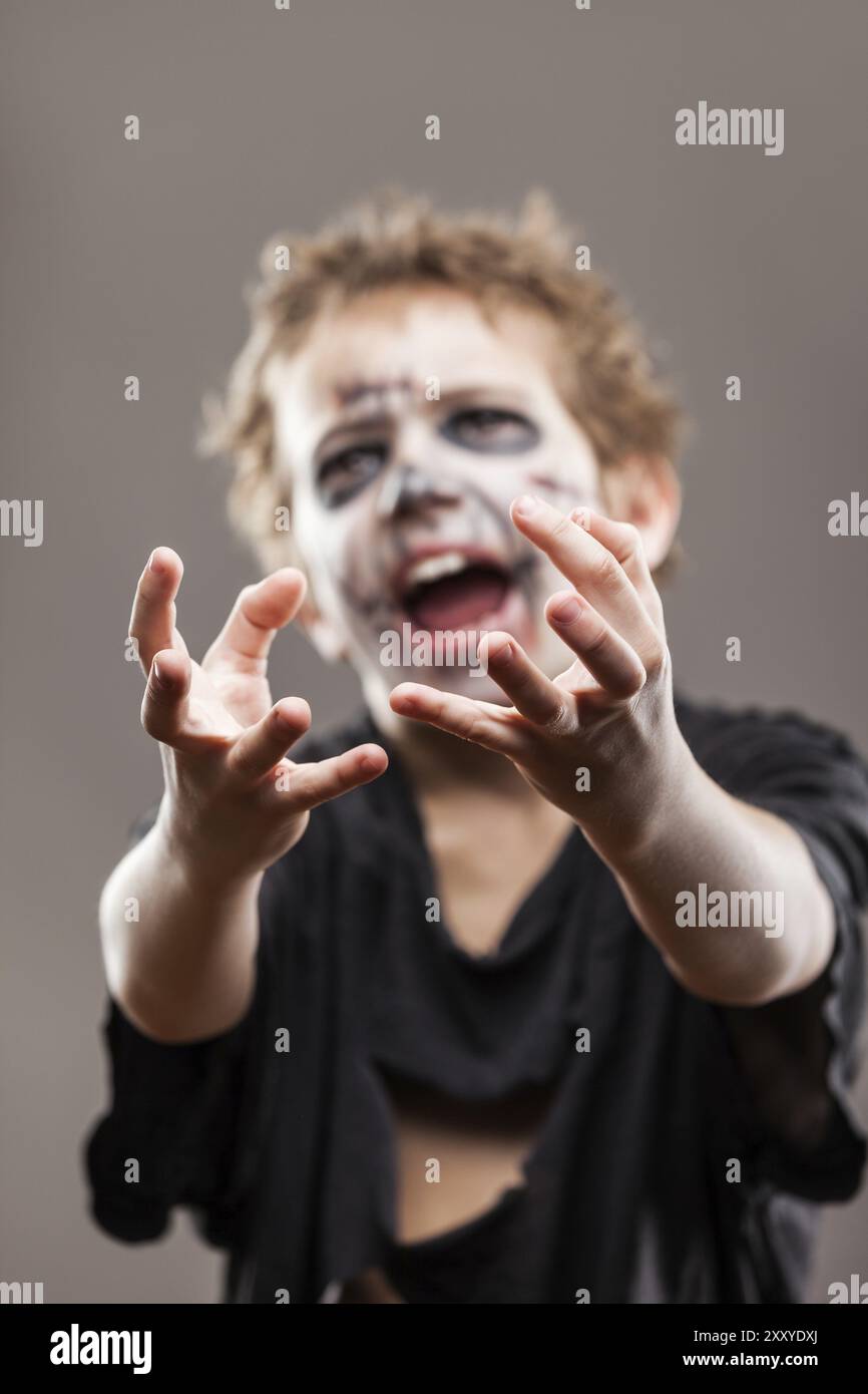 Halloween or horror concept, screaming walking dead zombie child boy ...