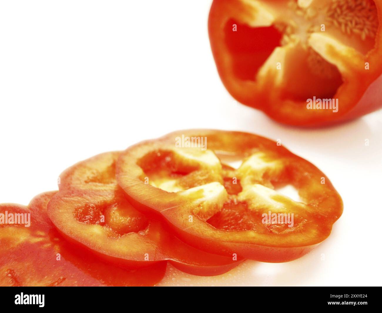 Red pepper vegetable, sliced, closeup towards white background Stock ...