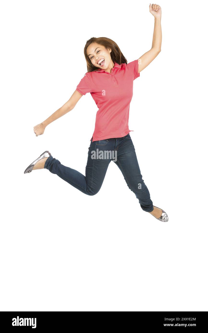 Asian woman celebrating in mid-air jumping with exaggerated smile, arms ...