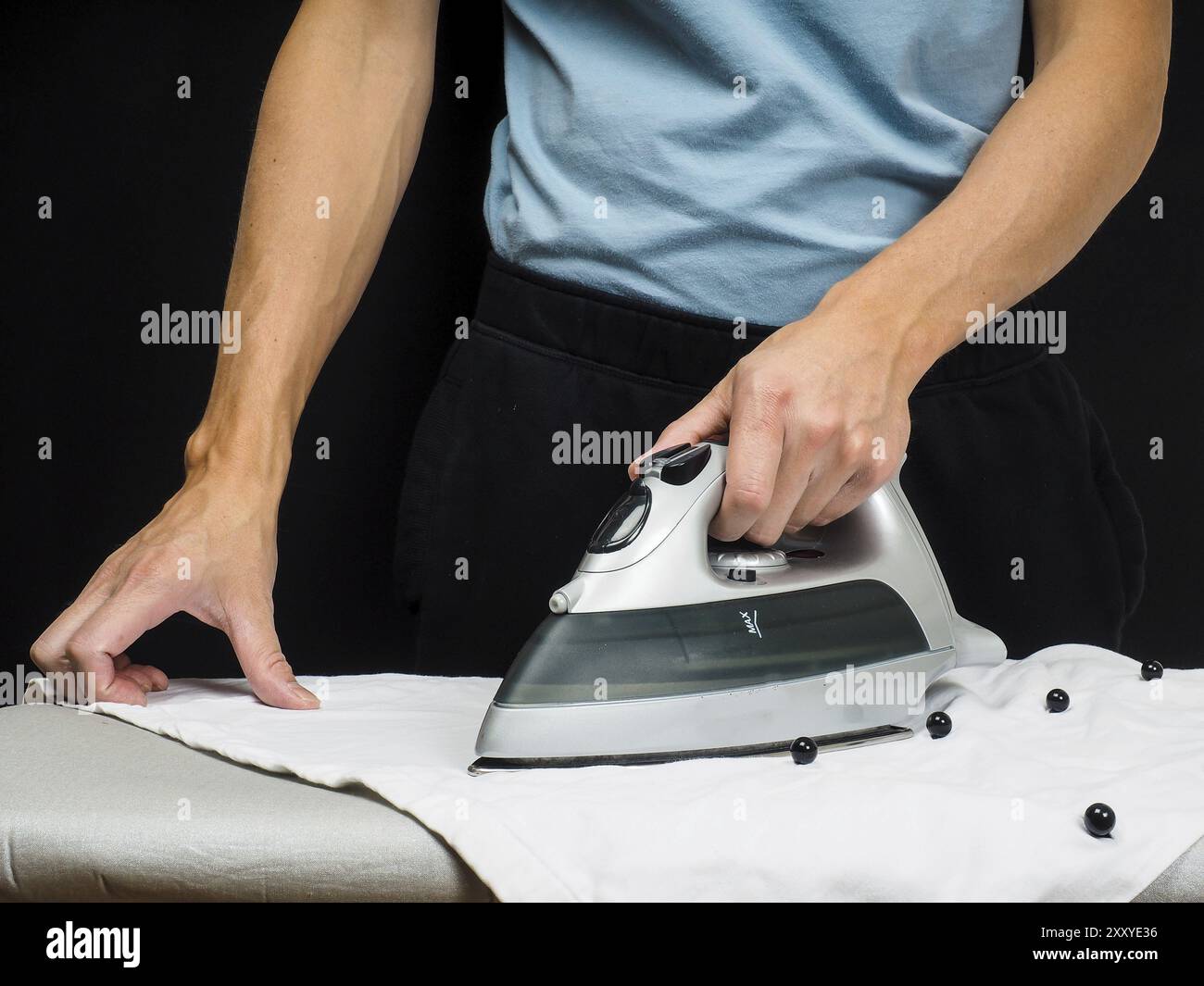 Male person using a steaming hot iron, on a white shirt Stock Photo - Alamy