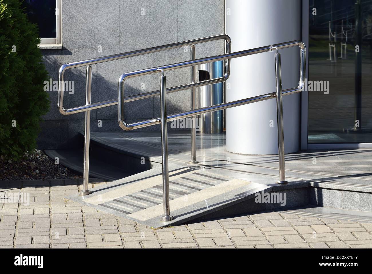 Ramp for wheelchair entry with metal handrails Stock Photo - Alamy