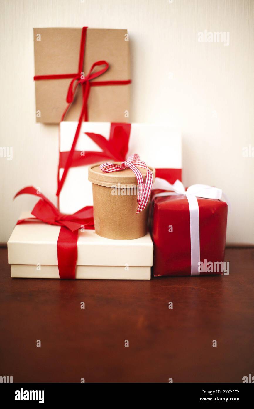 Handmade Christmas presents wrapped in paper with red and white ribbons ...