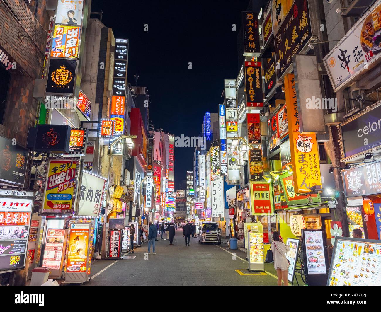 Shops and restaurants at night on Kabukicho Ichiban Gai Street in ...