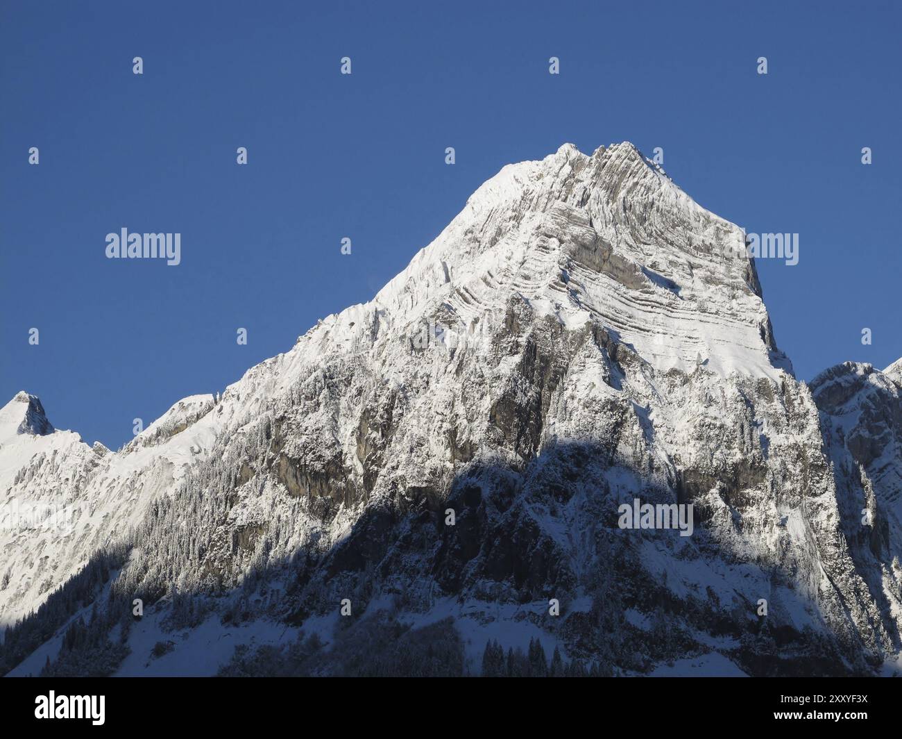 Snow Capped Mountain Peak With Visible Rock Layers Stock Photo - Alamy