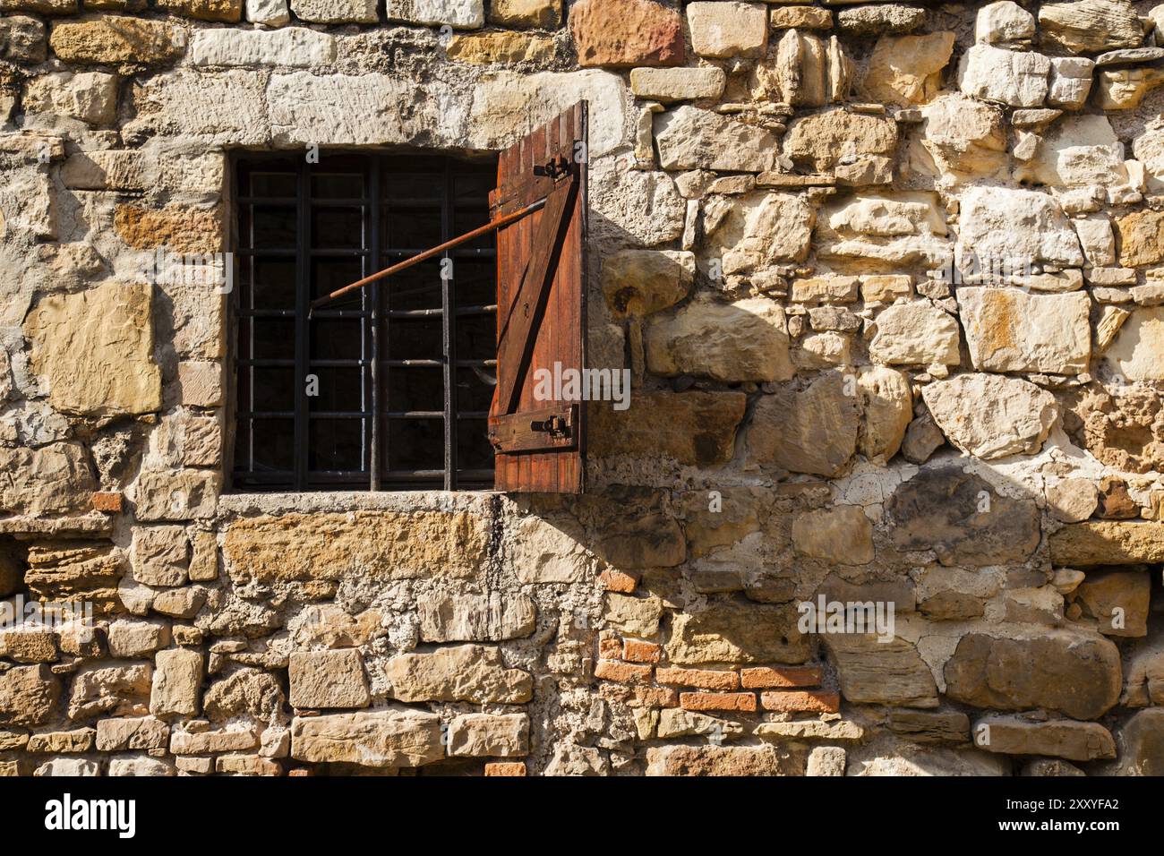Gravel wall with barred window Stock Photo - Alamy