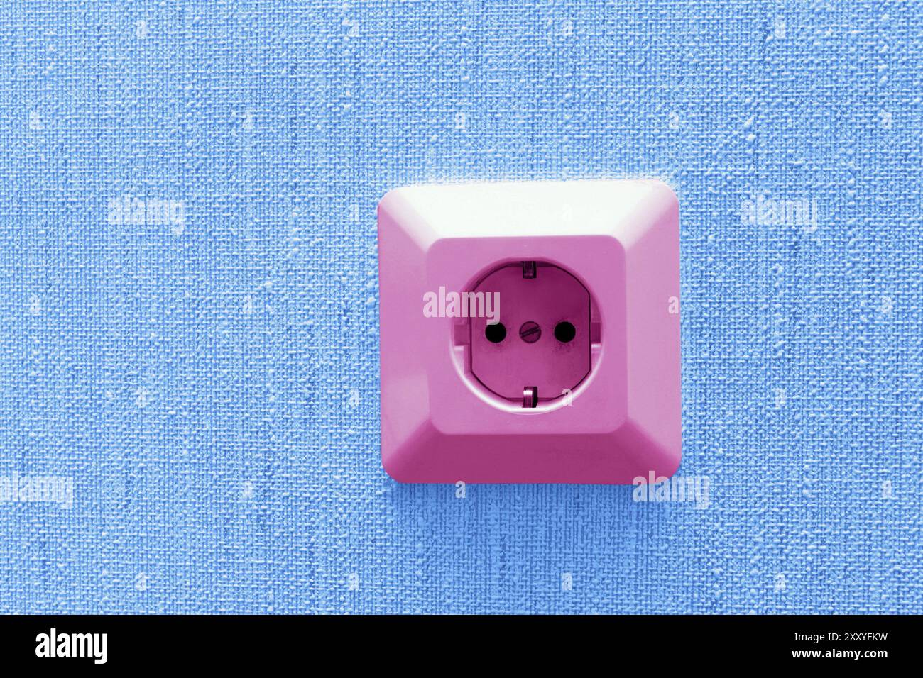 Pink electric socket on blue wall, abstract background Stock Photo - Alamy