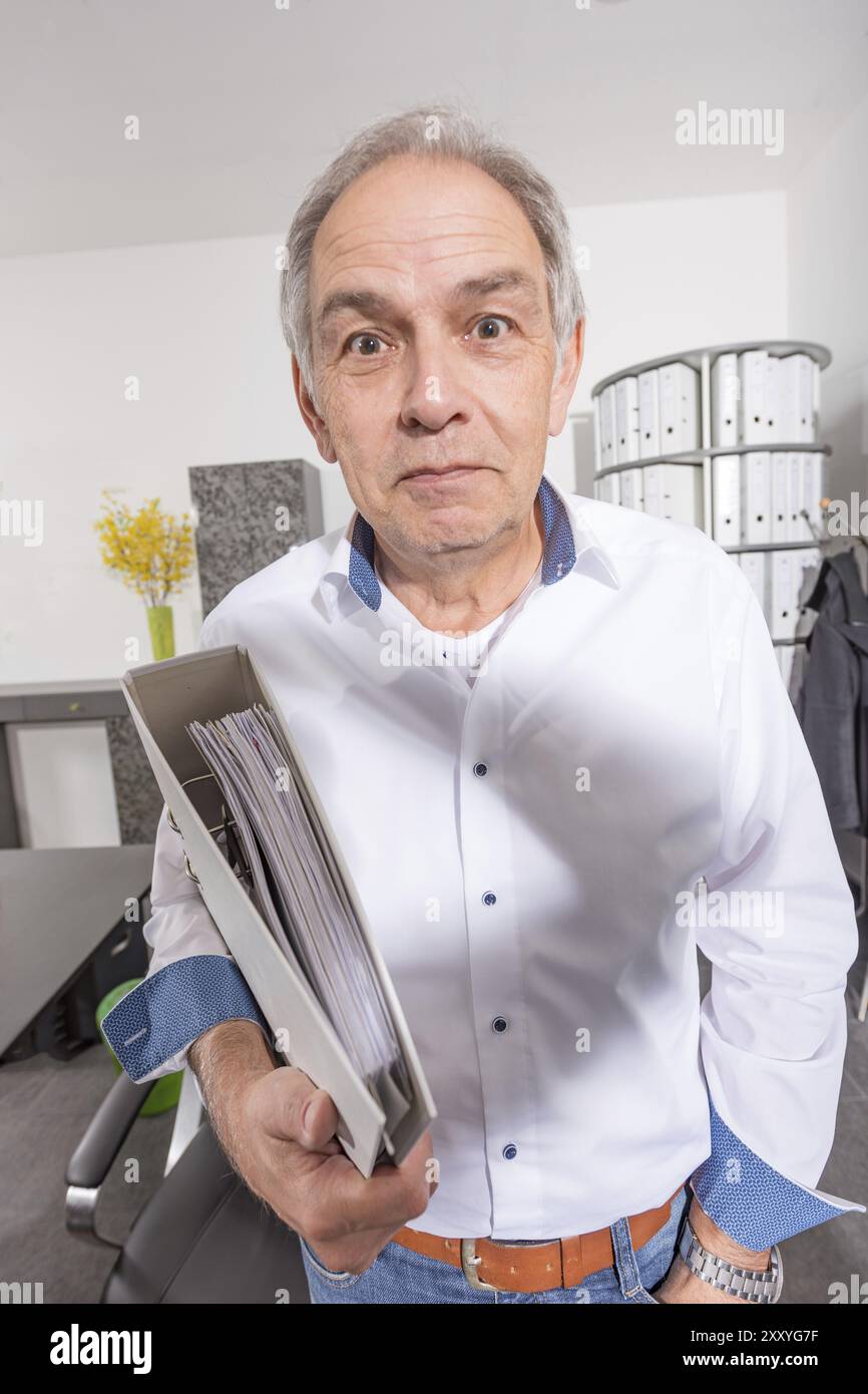Older man in a white shirt hands over a file folder Stock Photo - Alamy