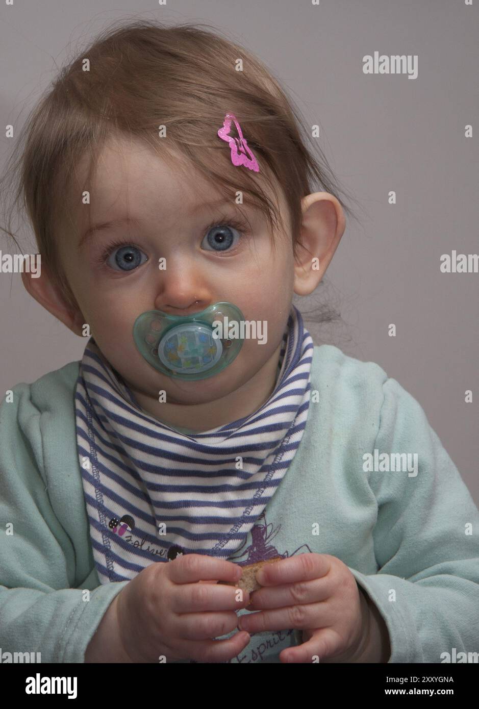 Little girl with a dummy in her mouth Stock Photo - Alamy