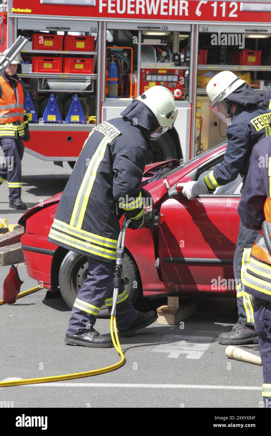 Firefighters opening a car with scissors and spreader Stock Photo - Alamy
