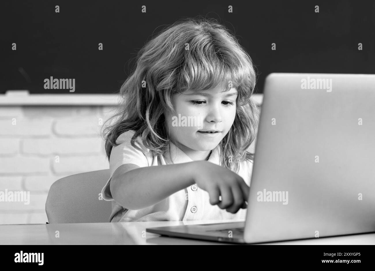 Cute little child using laptop computer, kid boy studying through ...