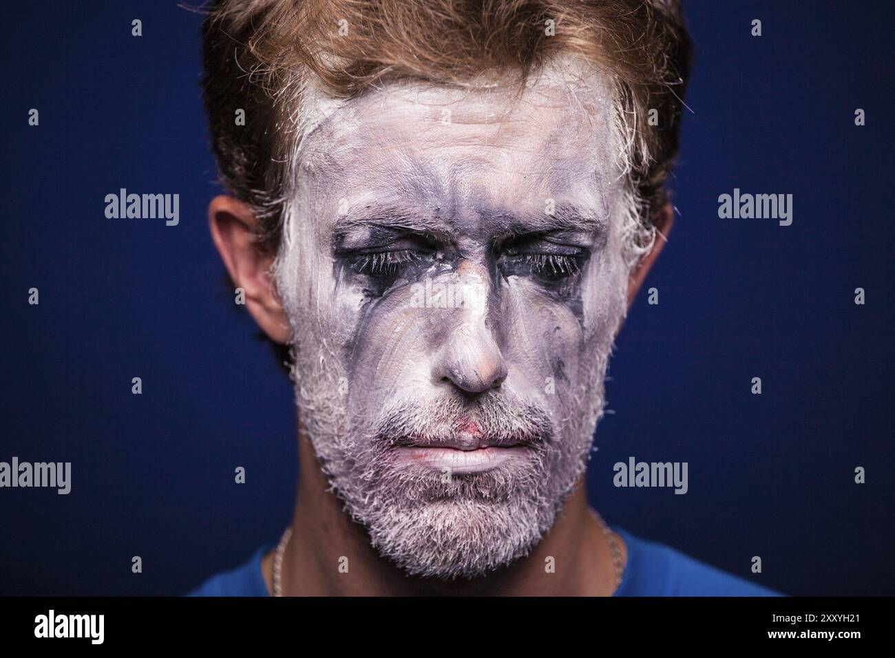 Face crying mime on a blue background Stock Photo - Alamy