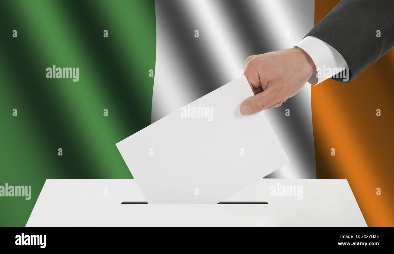 The irish flag and the hand with the bulletin about the ballot box ...