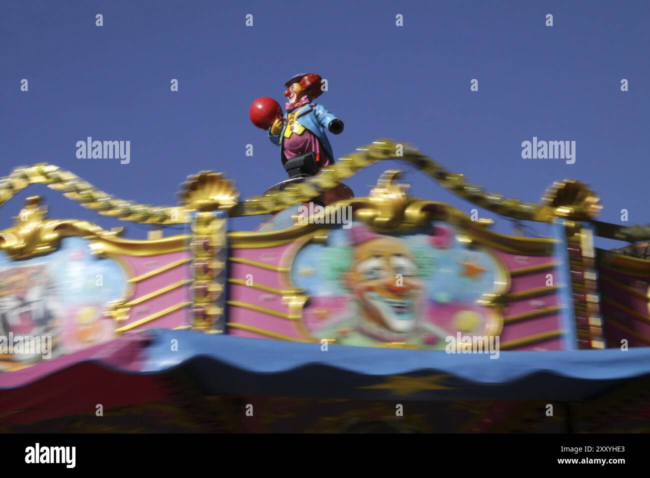 Children's carousel with clown Stock Photo - Alamy