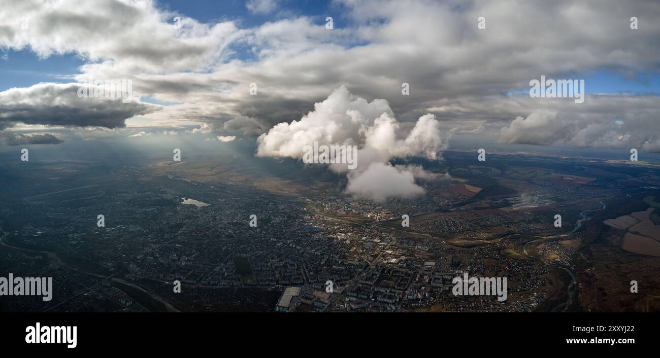 Aerial view from airplane window at high altitude of distant city ...