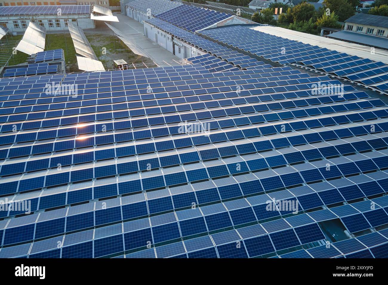 Aerial view of blue photovoltaic solar panels mounted on industrial ...