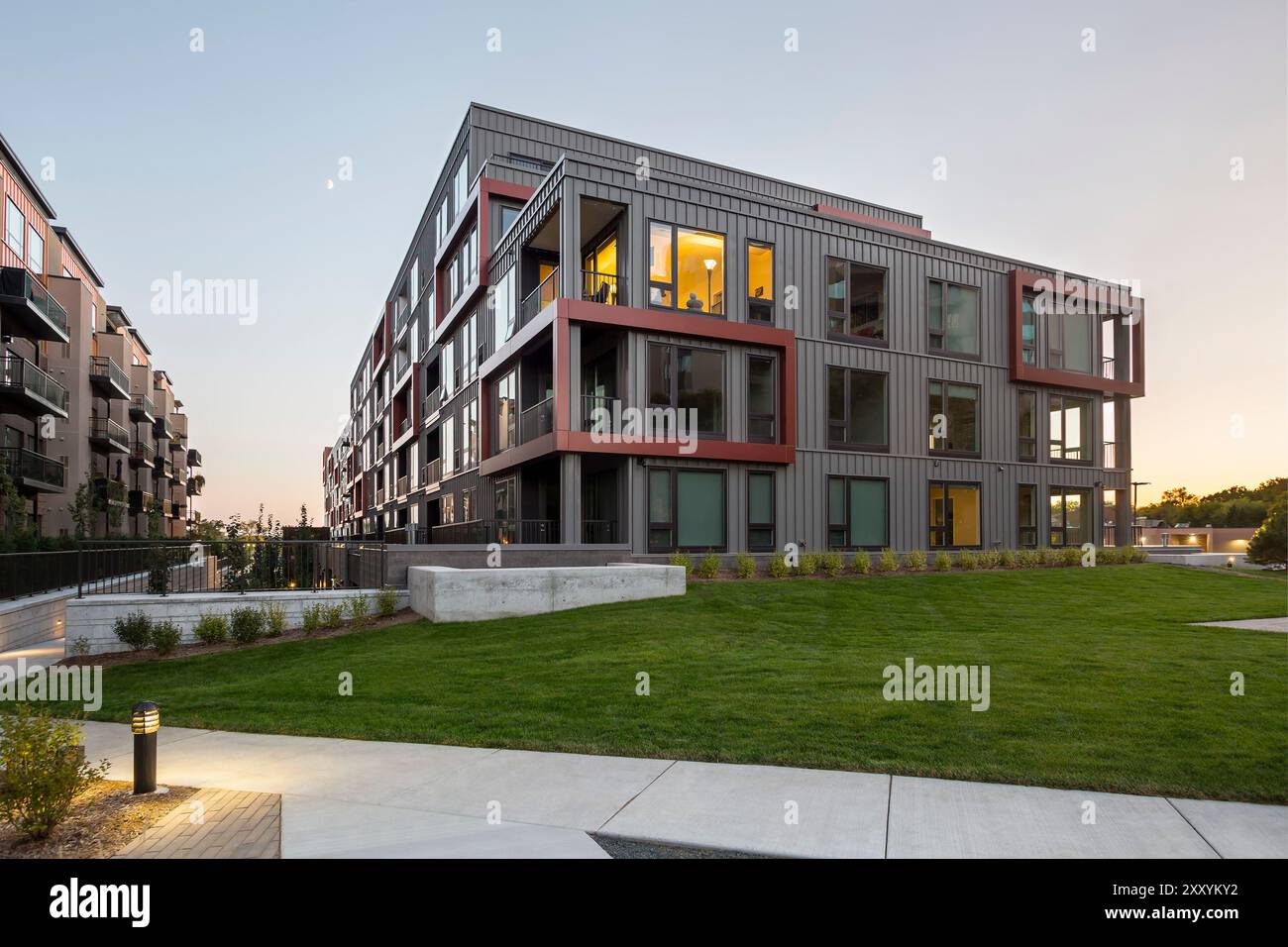 Side and back exterior of new modern apartment building at dusk Stock ...