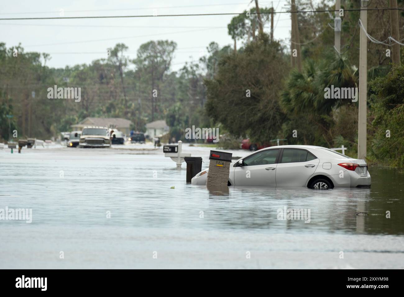 Flooded town street with trapped car submerged under water in Florida ...