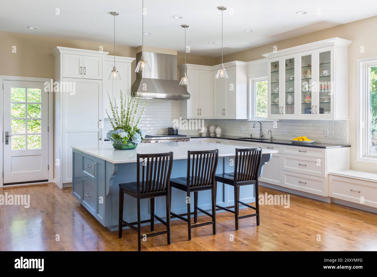 New white kitchen with vibrant blue painted island Stock Photo - Alamy