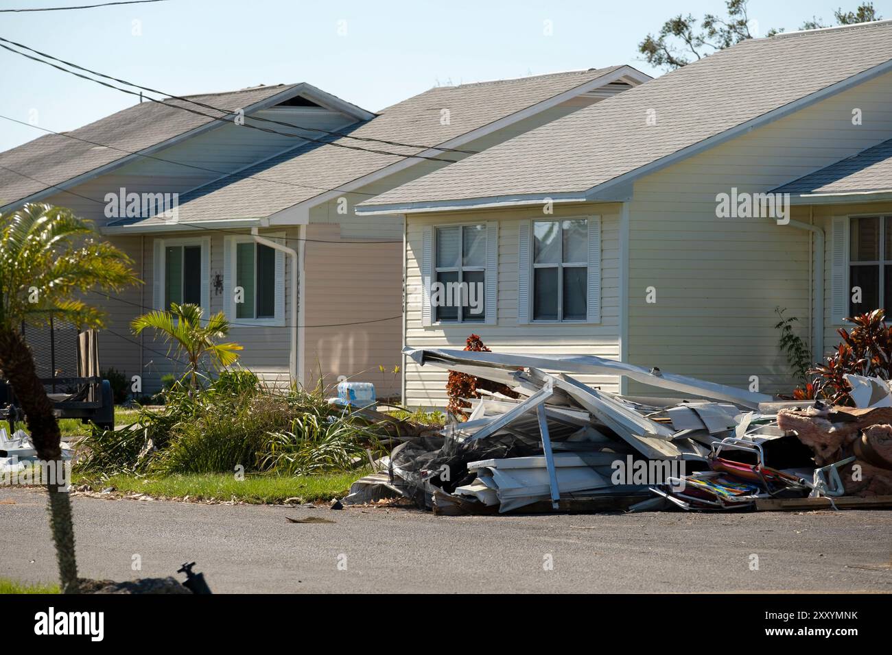Heaps of debris rubbish on street side near severely damaged by ...