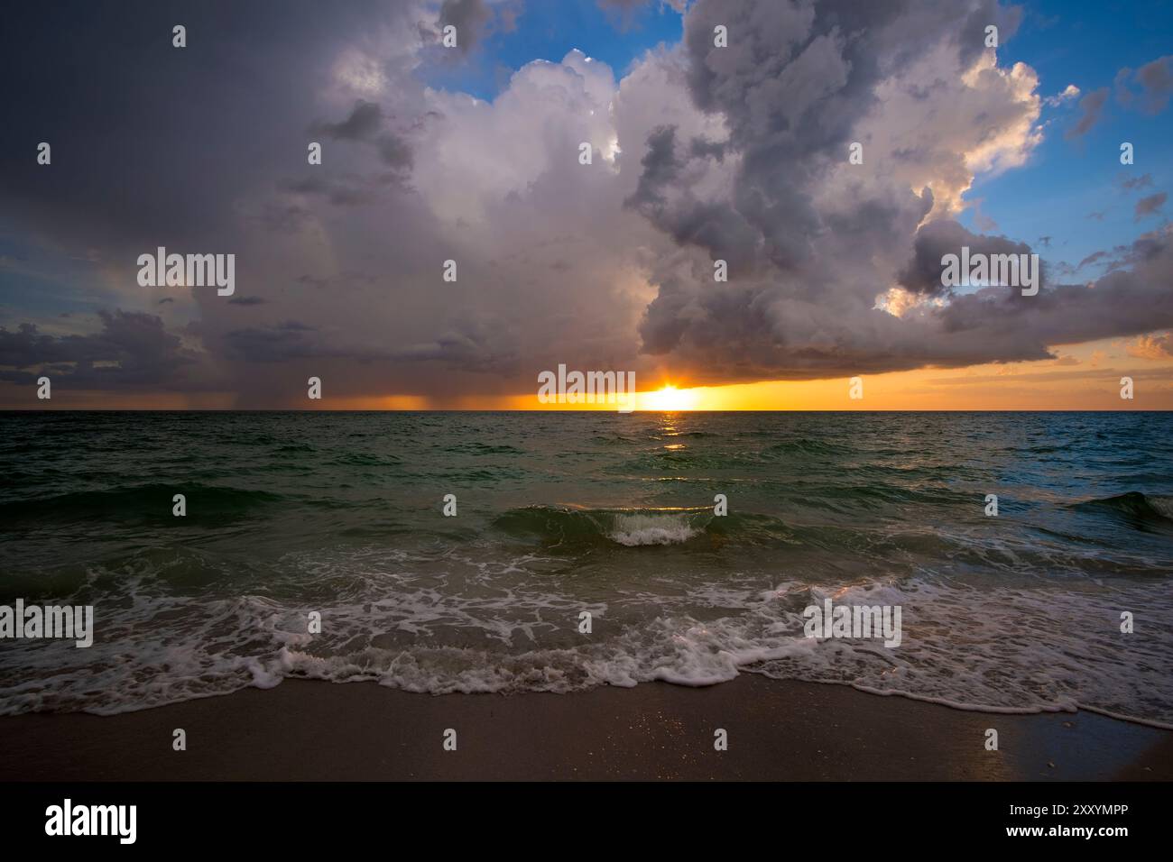 Heavy rain falling down over dark ocean at sunset. Extreme Florida ...