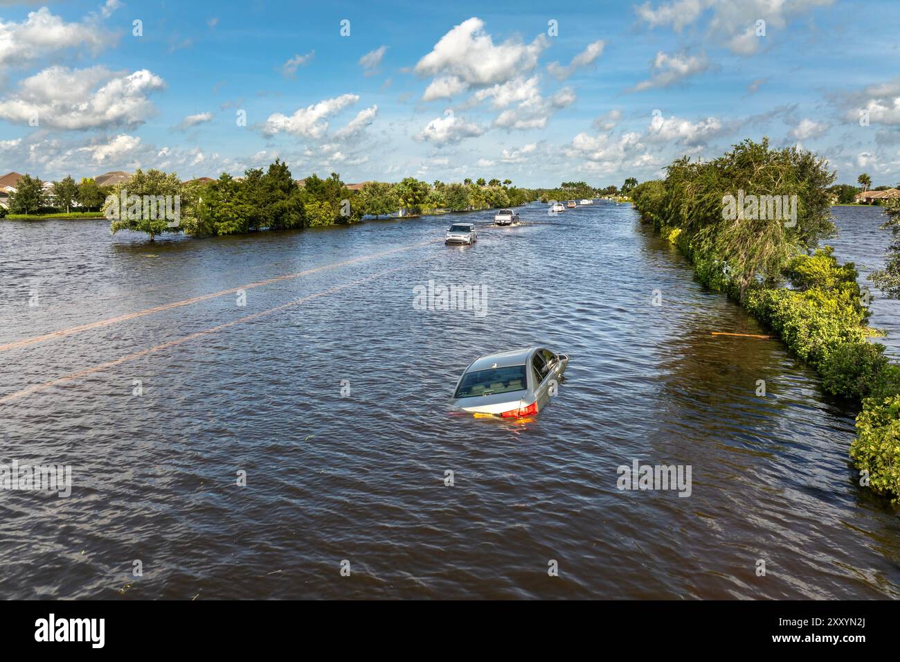 Hurricane rainfall flooded road. Drowned car on city street in Florida ...