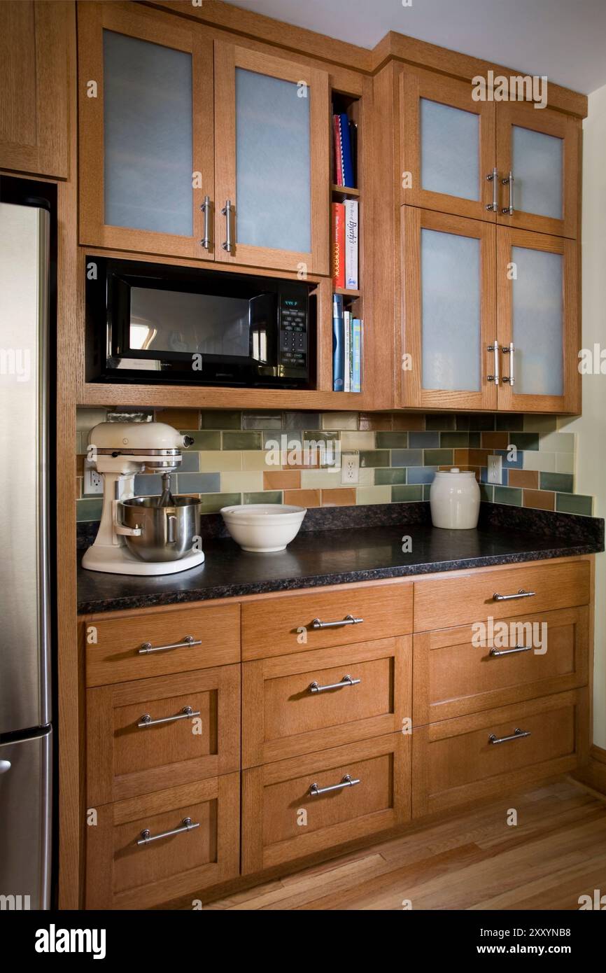 Cabinets in corner of kitchen showing built in microwave and electric ...