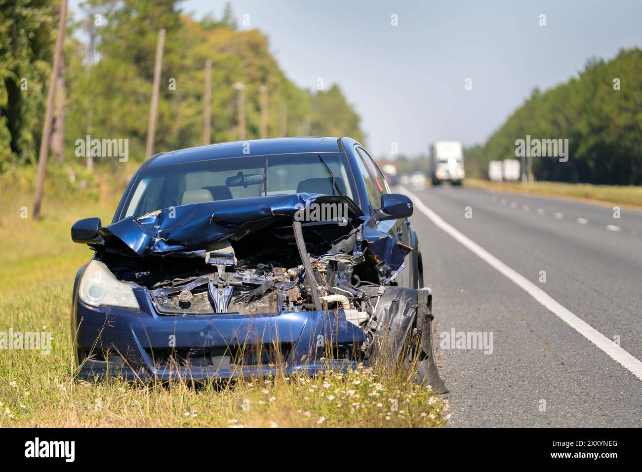 Old crashed car abandoned on highway road shoulder. Damaged in traffic ...