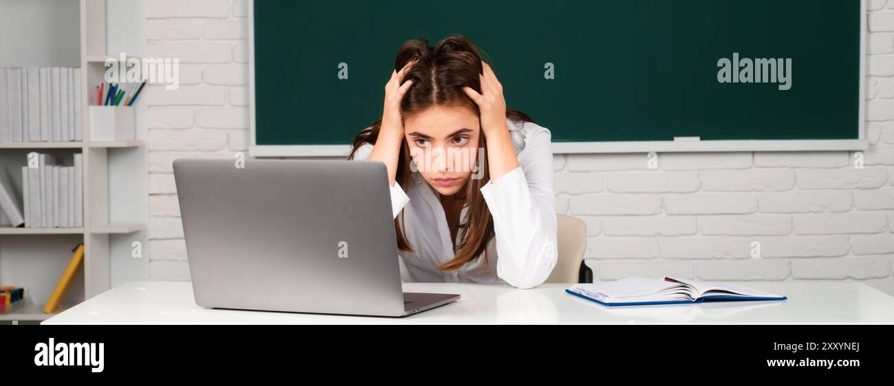 Sad and angry student, cute young school girl using computer at school ...
