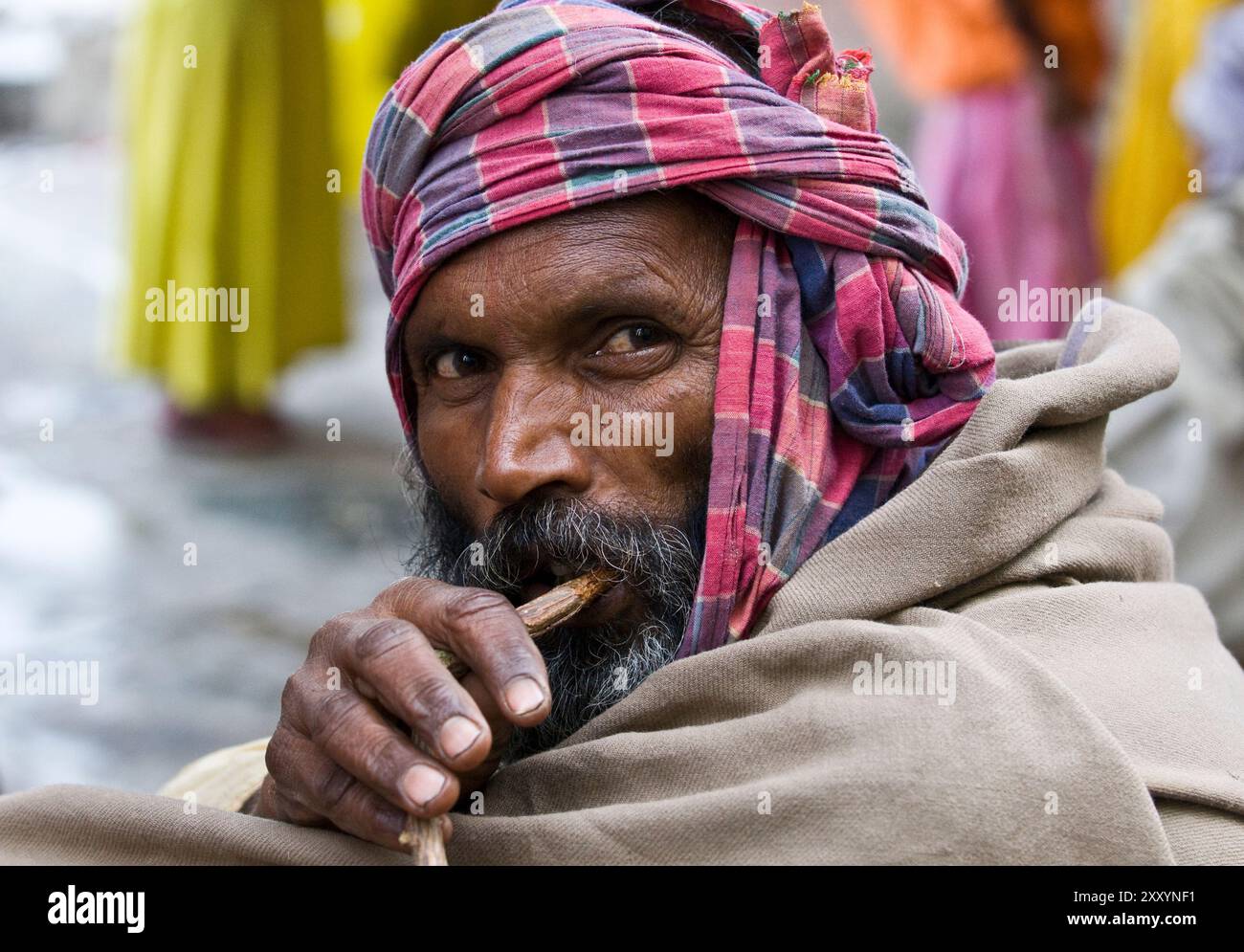 A Bengali man cleaning his teeth with a traditional toothbrush in ...