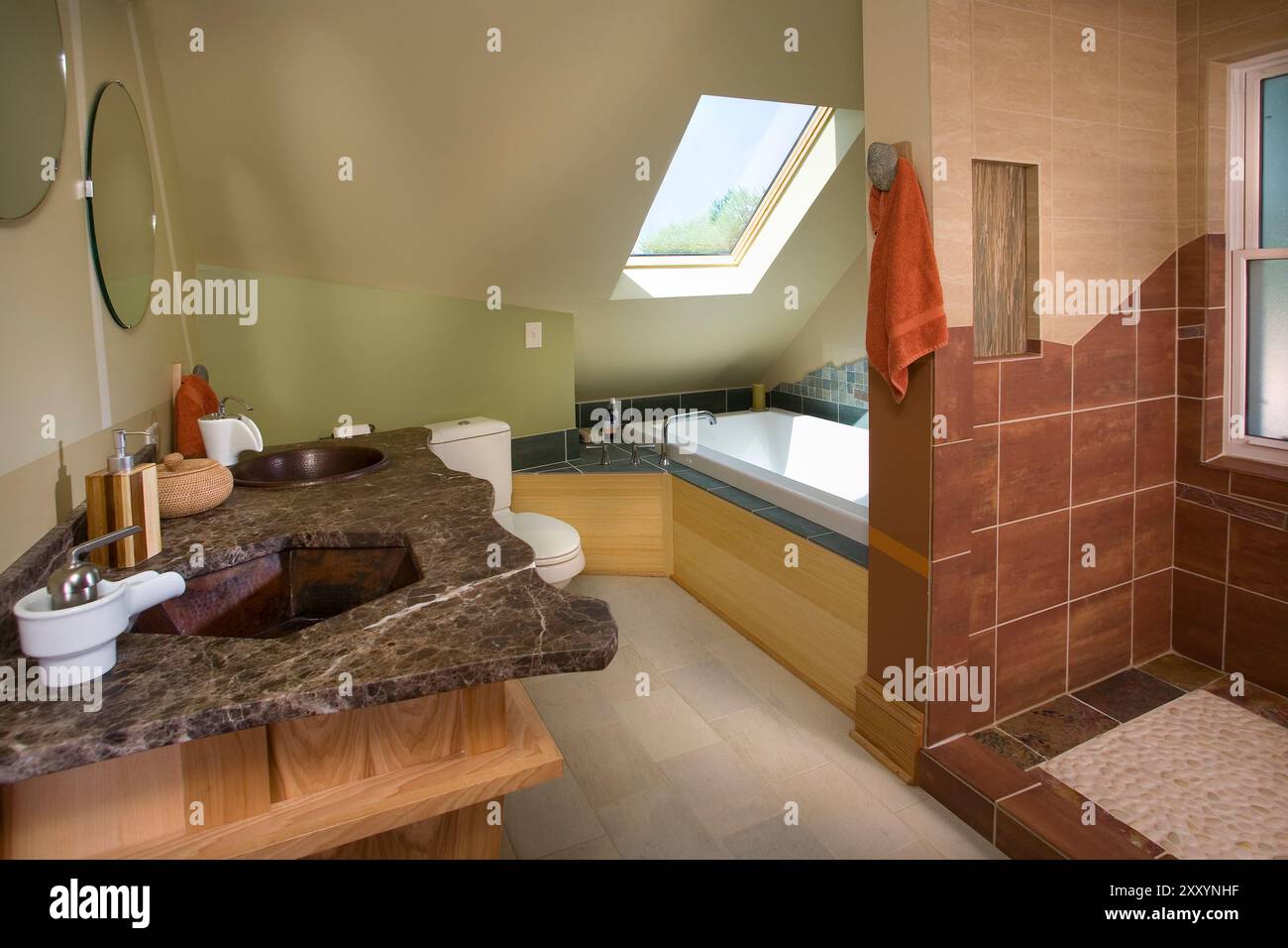 Bathroom with sloping ceiling and skylight over tub Stock Photo - Alamy