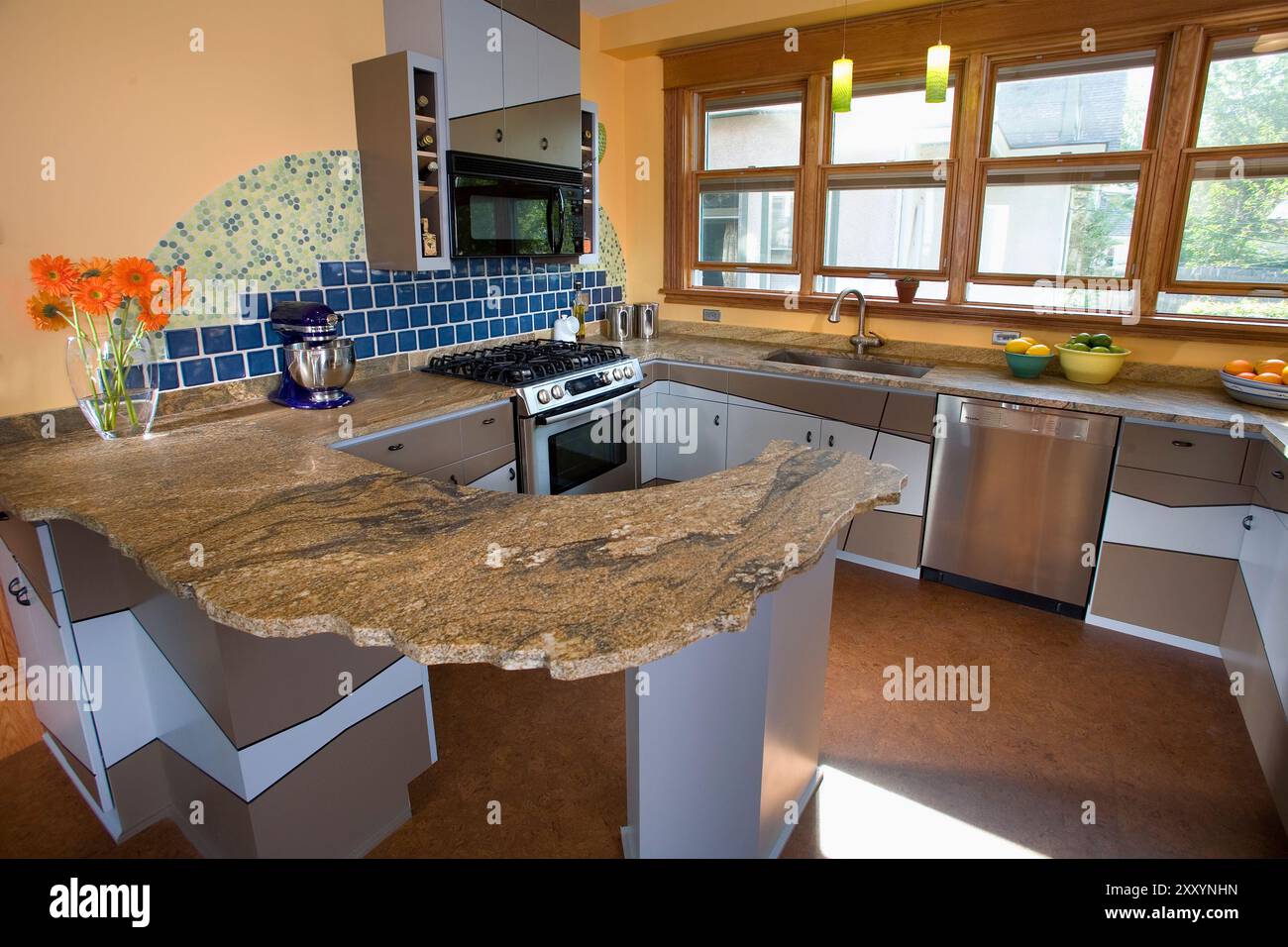 Photo of kitchen from higher angle showing irregularly shaped granite ...