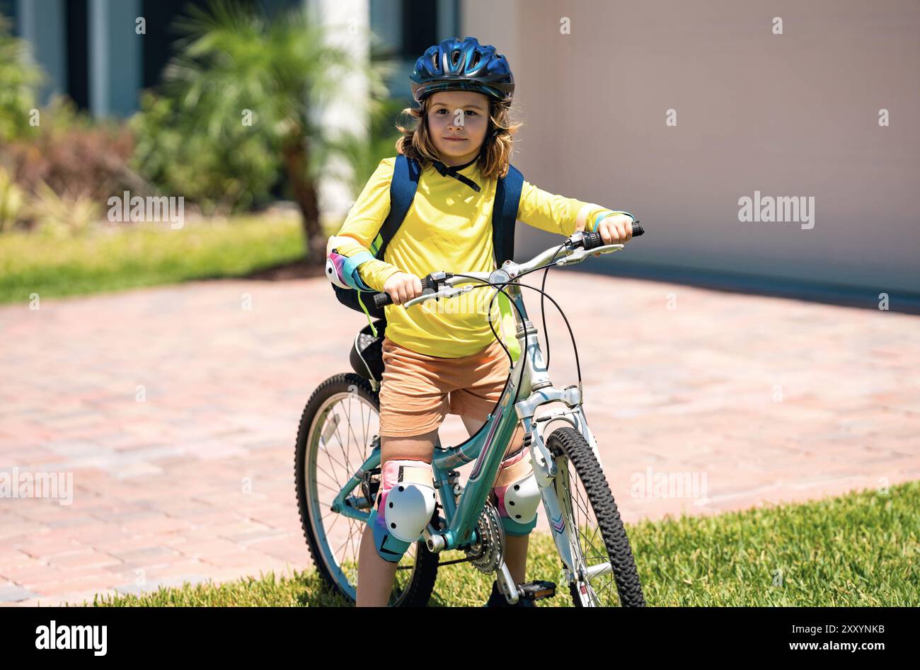 Kid riding bike in a helmet. Child riding bike in protective helmet ...