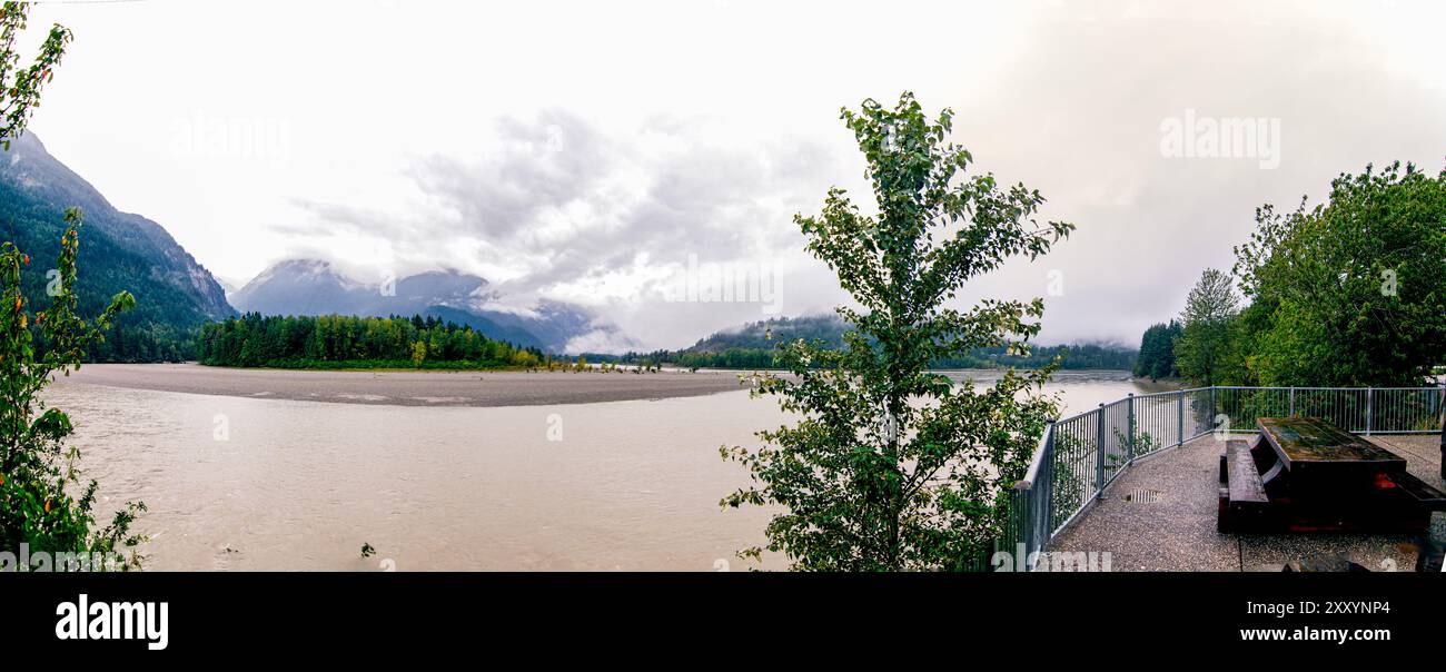Fraser River with cloud covered green mountains in the background at ...