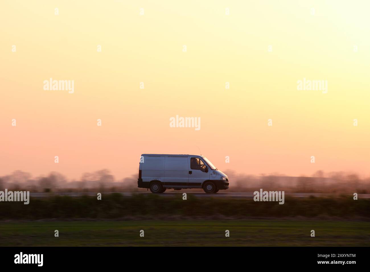Small cargo van driving on highway hauling goods. Delivery ...