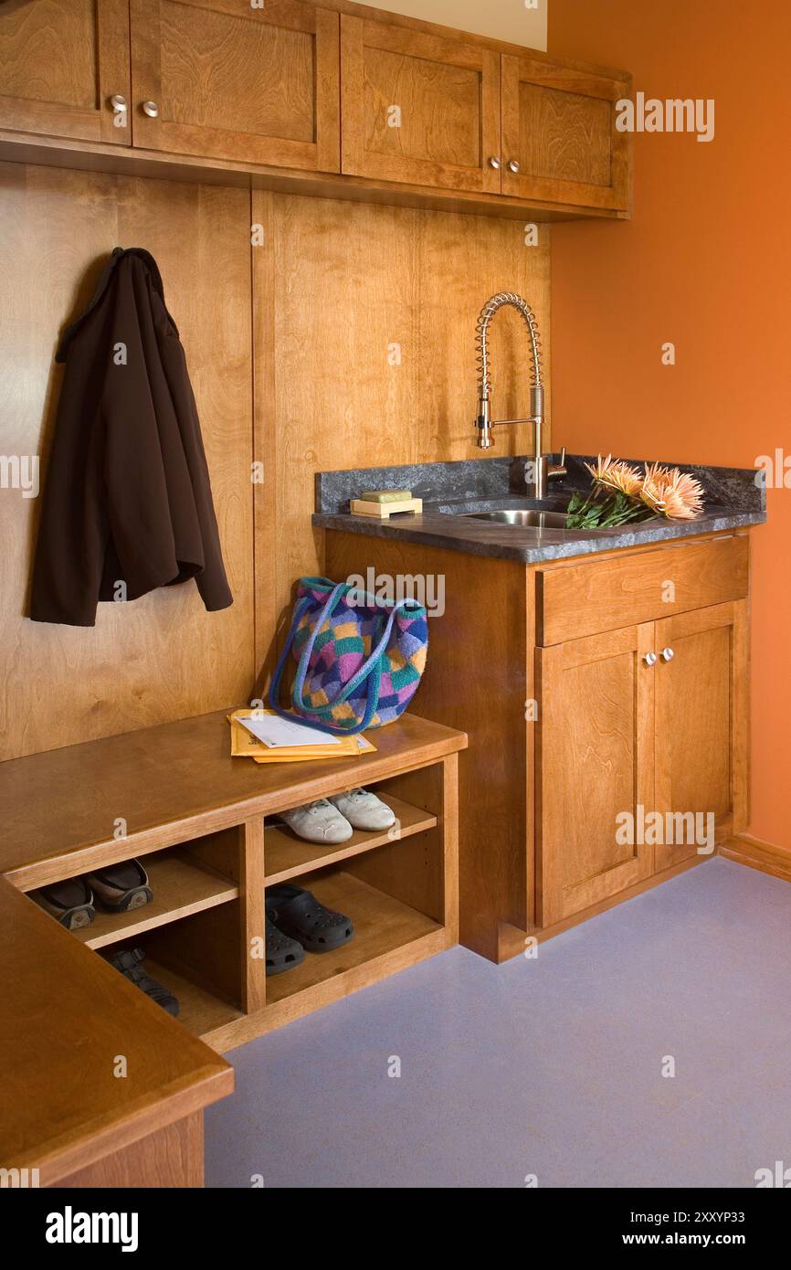 Mudroom with storage, bench, sink and high end faucet Stock Photo - Alamy