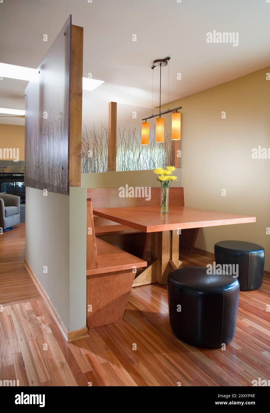 Built in seating area with leather ottomans and fireplace and sitting ...