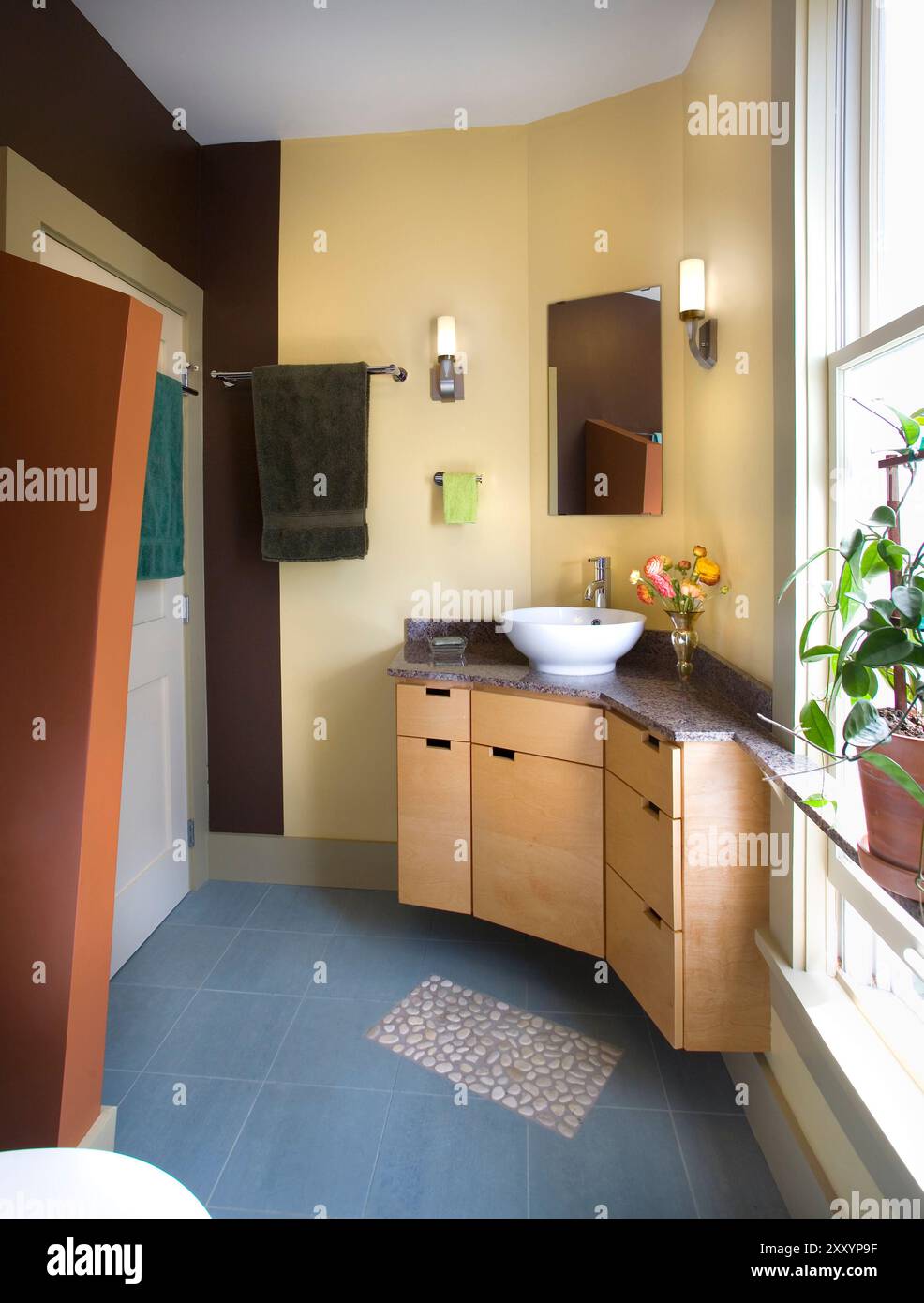 Bathroom vanity built onto wall with stone tile inset on floor Stock ...