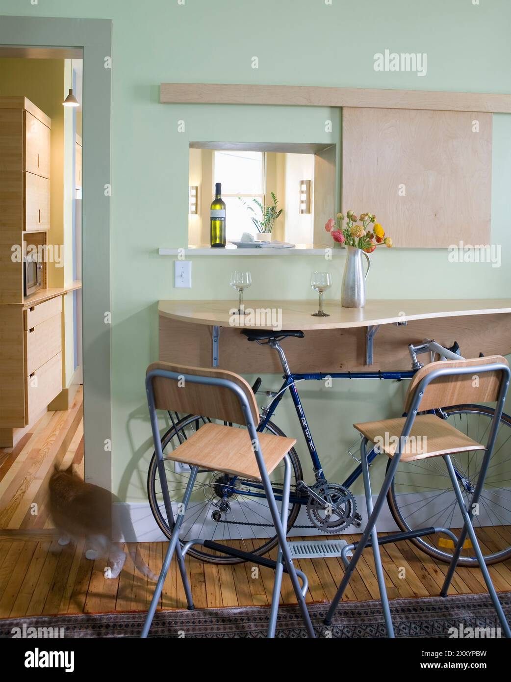 View into kitchen through window with small counter and bike in ...