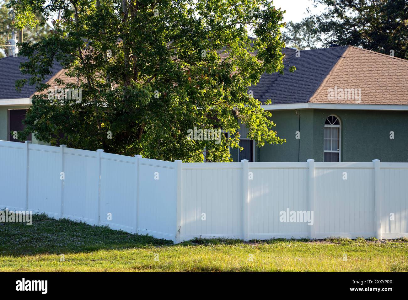 White plastic fence for back yard protection and privacy Stock Photo ...