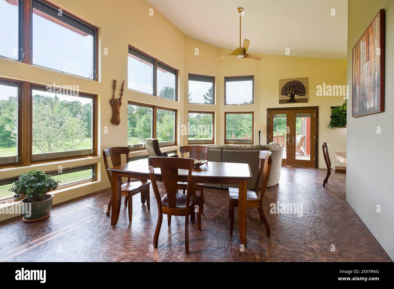 Combined dining and living room with lots of windows in sunny passive ...